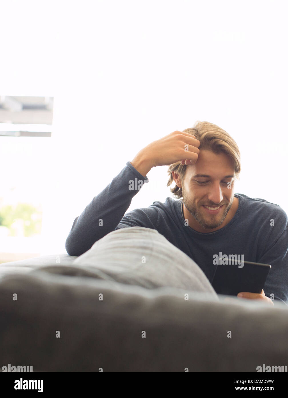 Young man unwinding in comfortable hi-res stock photography and images ...