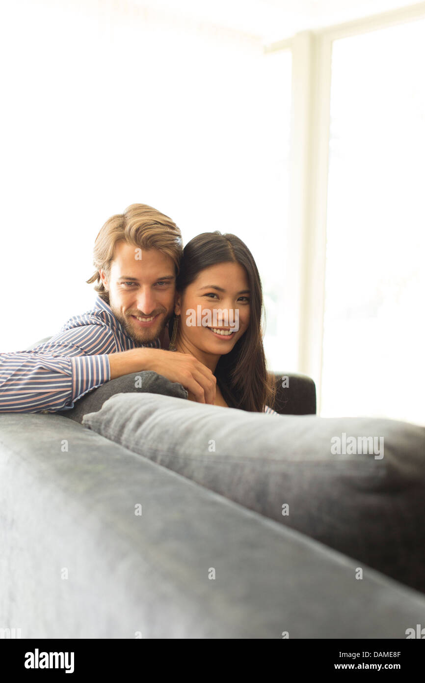Couple cuddling sofa hi-res stock photography and images - Alamy