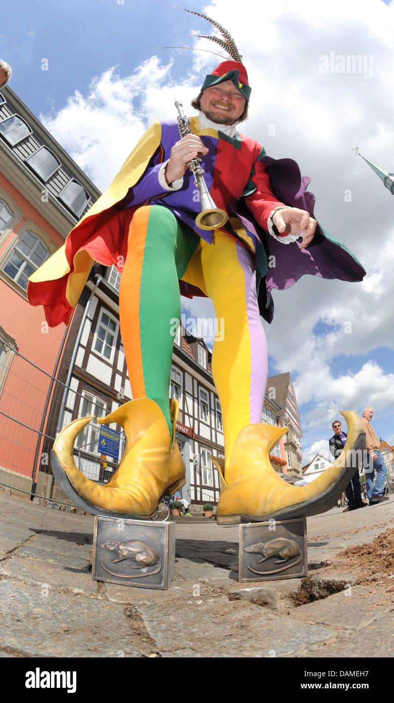 A Pied Piper of Hamelin, Michael Boyer, poses with two bronze emblems ...
