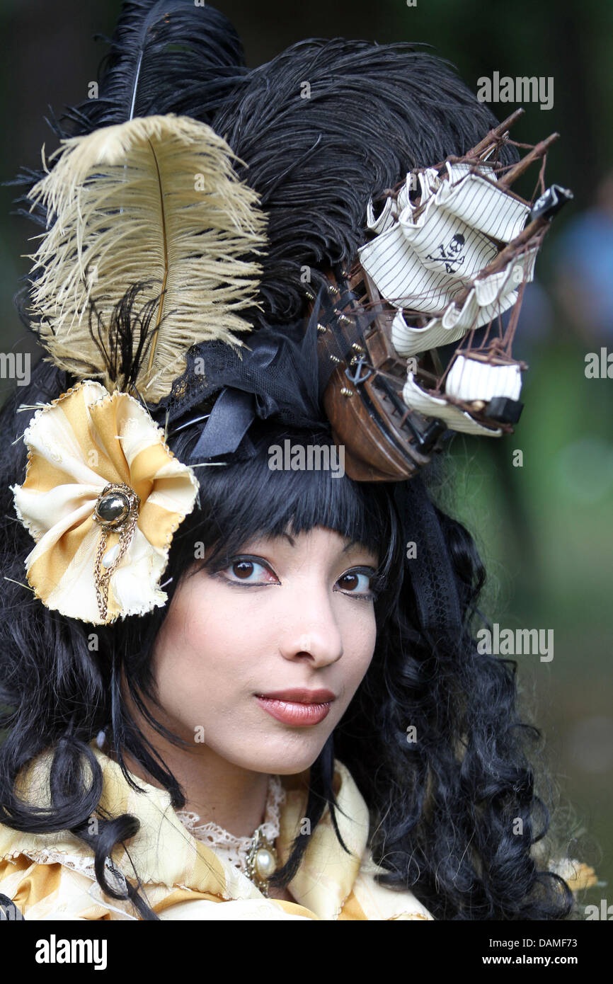A visitor to the Wave-Gotik-Treffen festival with a pirate ship in her ...