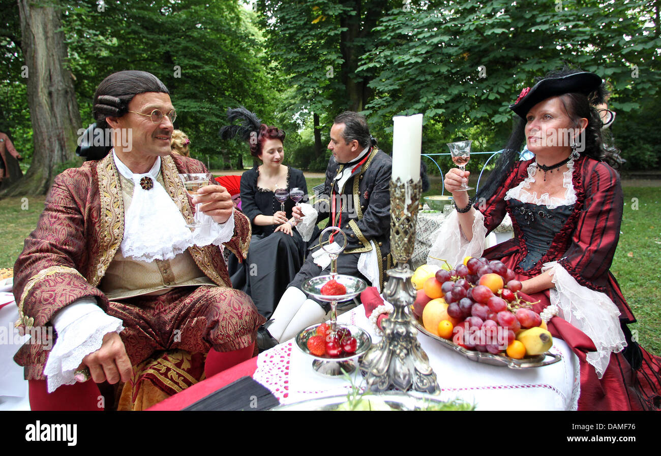 Visitors to the Wave-Gotik-Treffen festival have a picnick in a park in ...