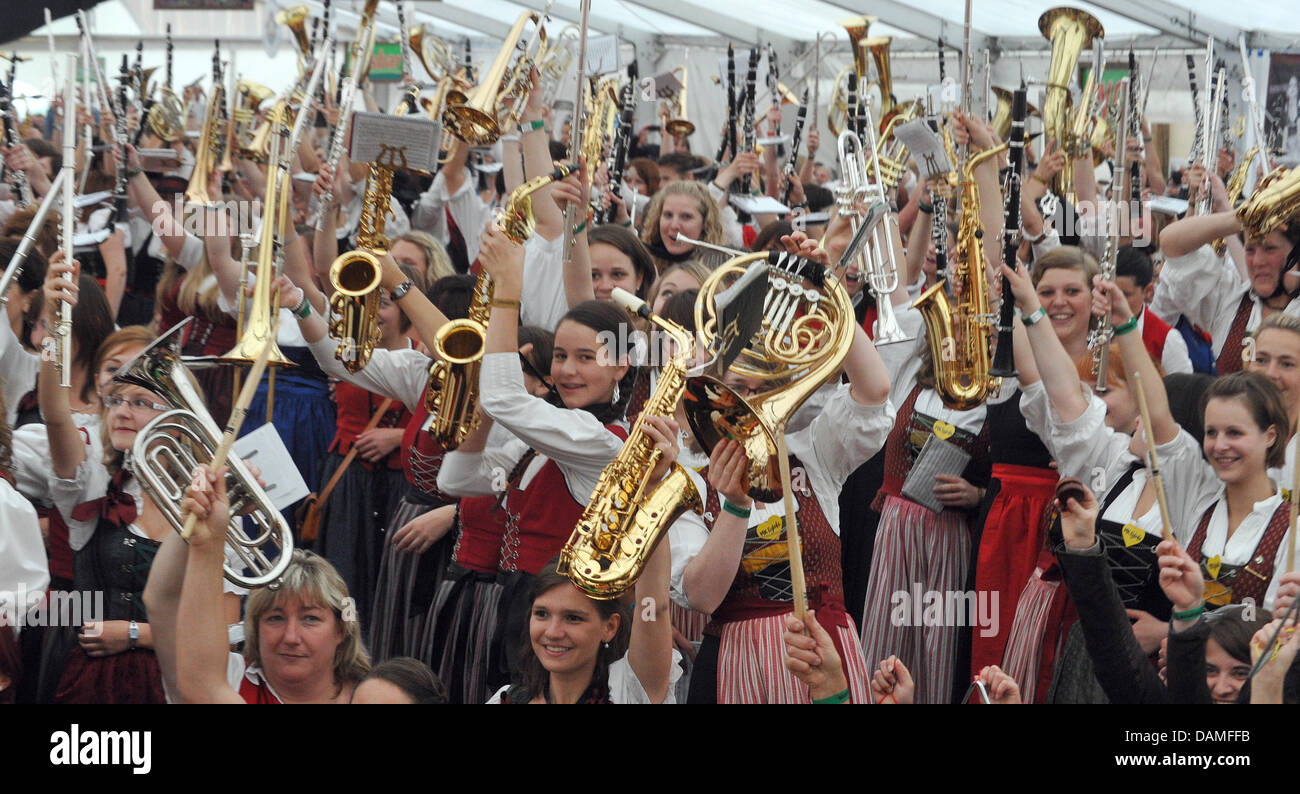 Women musicians raise their music instruments during a world record ...