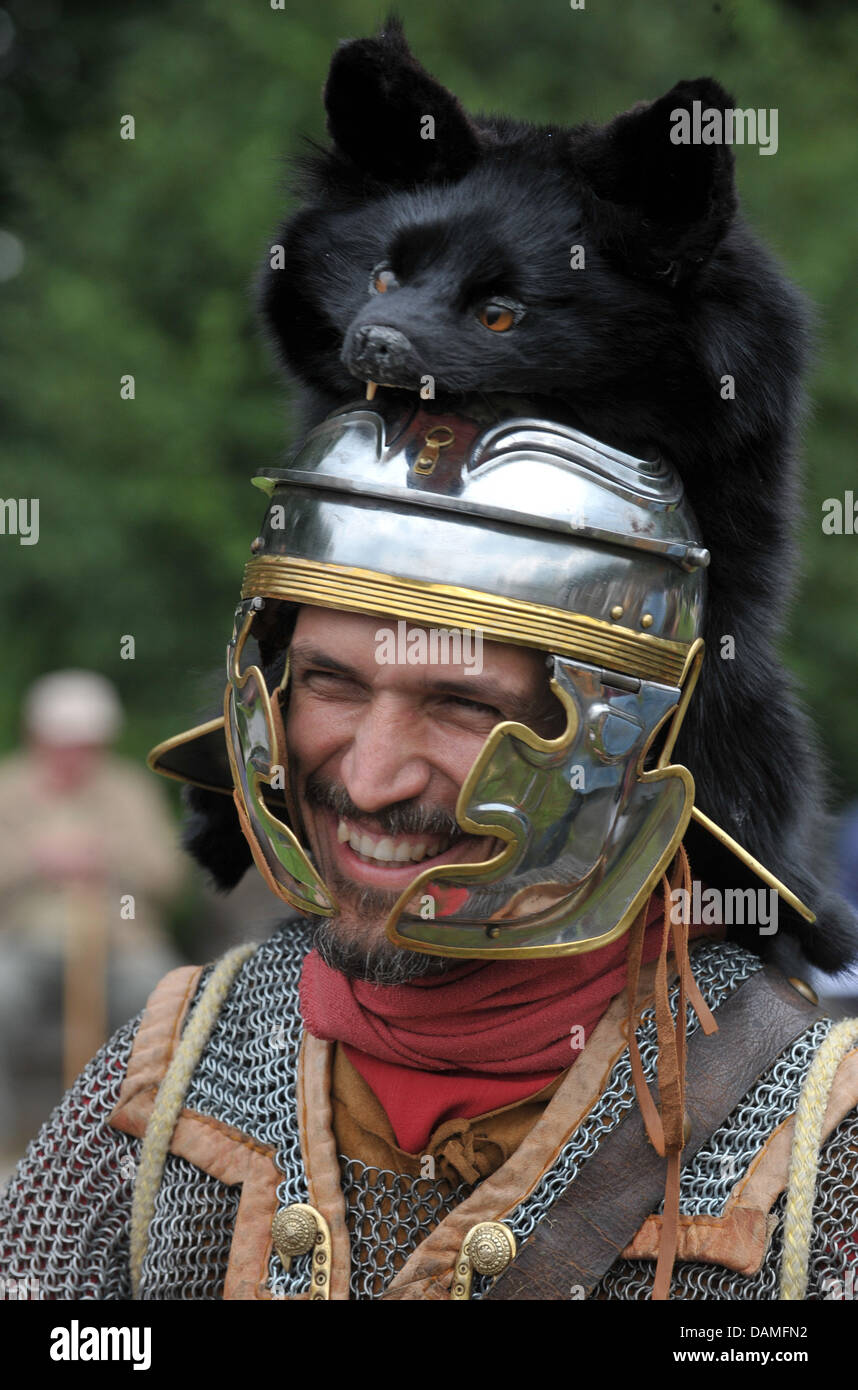 A lay actor wears an ancient Roman military garment and helmet during ...