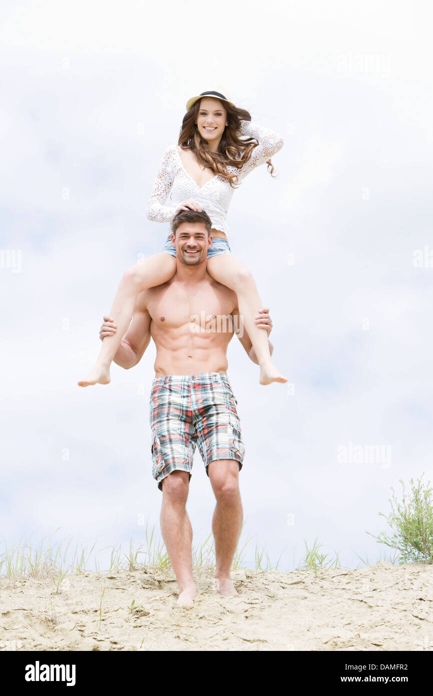 Germany, Bavaria, Young man carrying woman on shoulder Stock Photo - Alamy