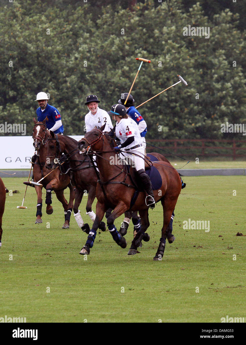Britain's Prince Harry (2nd to L) plays during the Sentebale Polo Cup ...