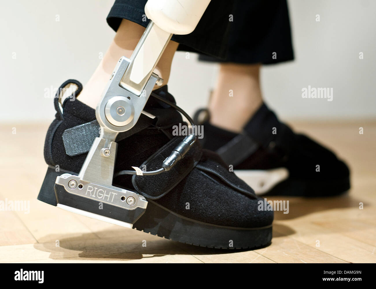 A young woman presents the robot suit 'Hybrid Assistive Limb'" (HAL) at ...