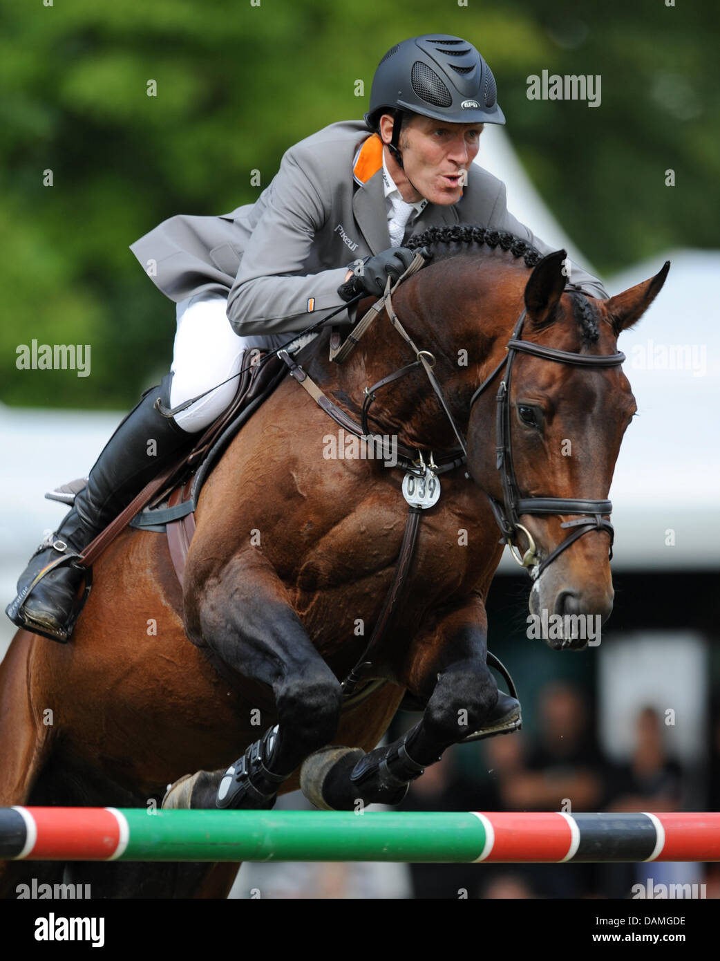Ludger Beerbaum jumps over an obstacle on his horse Chaman during the ...