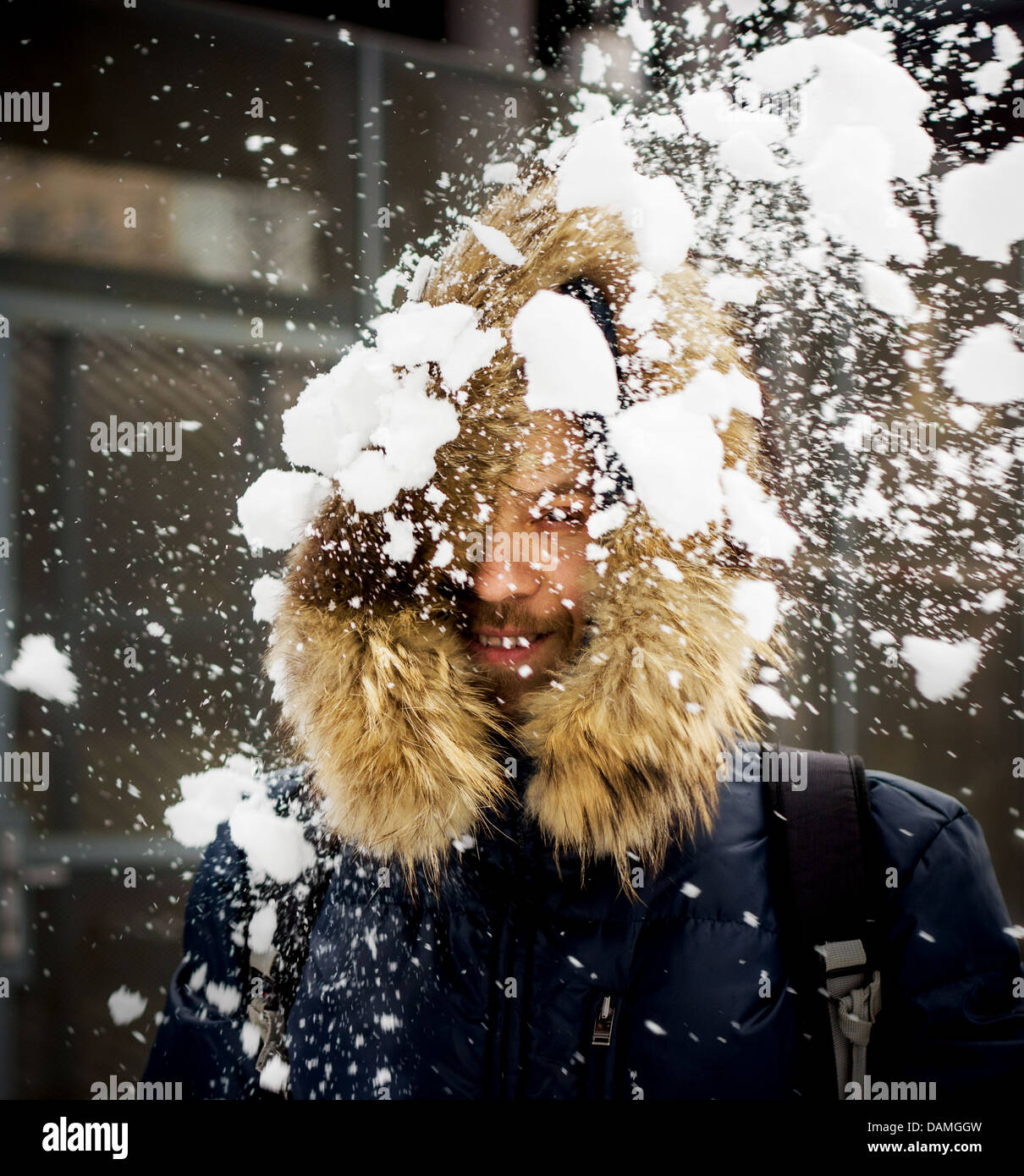 Young man is getting hit by a snowball Stock Photo - Alamy