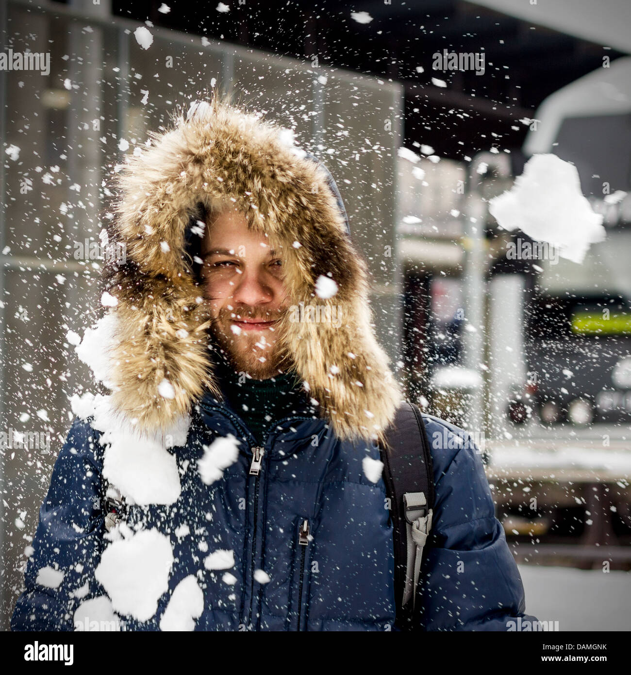 Young man is getting hit by a snowball Stock Photo - Alamy