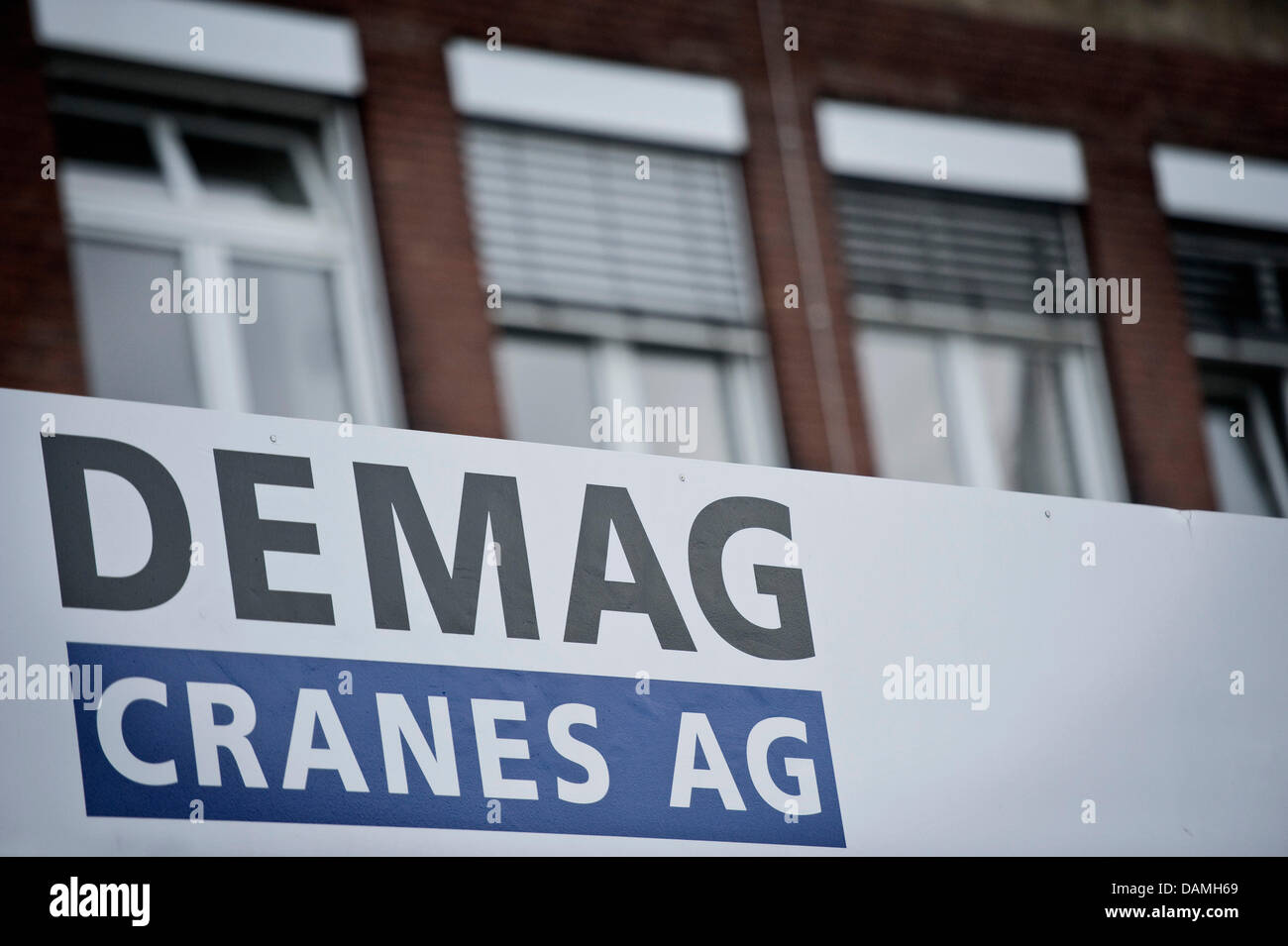 A sign with the logo of the Demag Cranes AG company is fixed on the ...