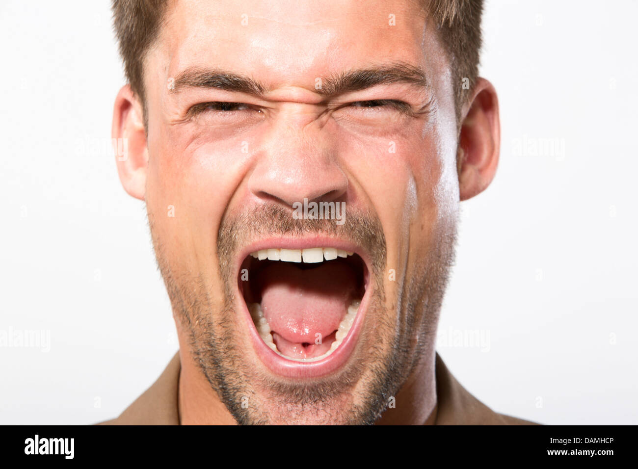 Young man screaming, close up Stock Photo - Alamy