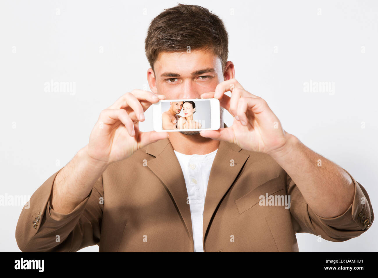 Young man showing picture with smartphone hi-res stock photography and ...