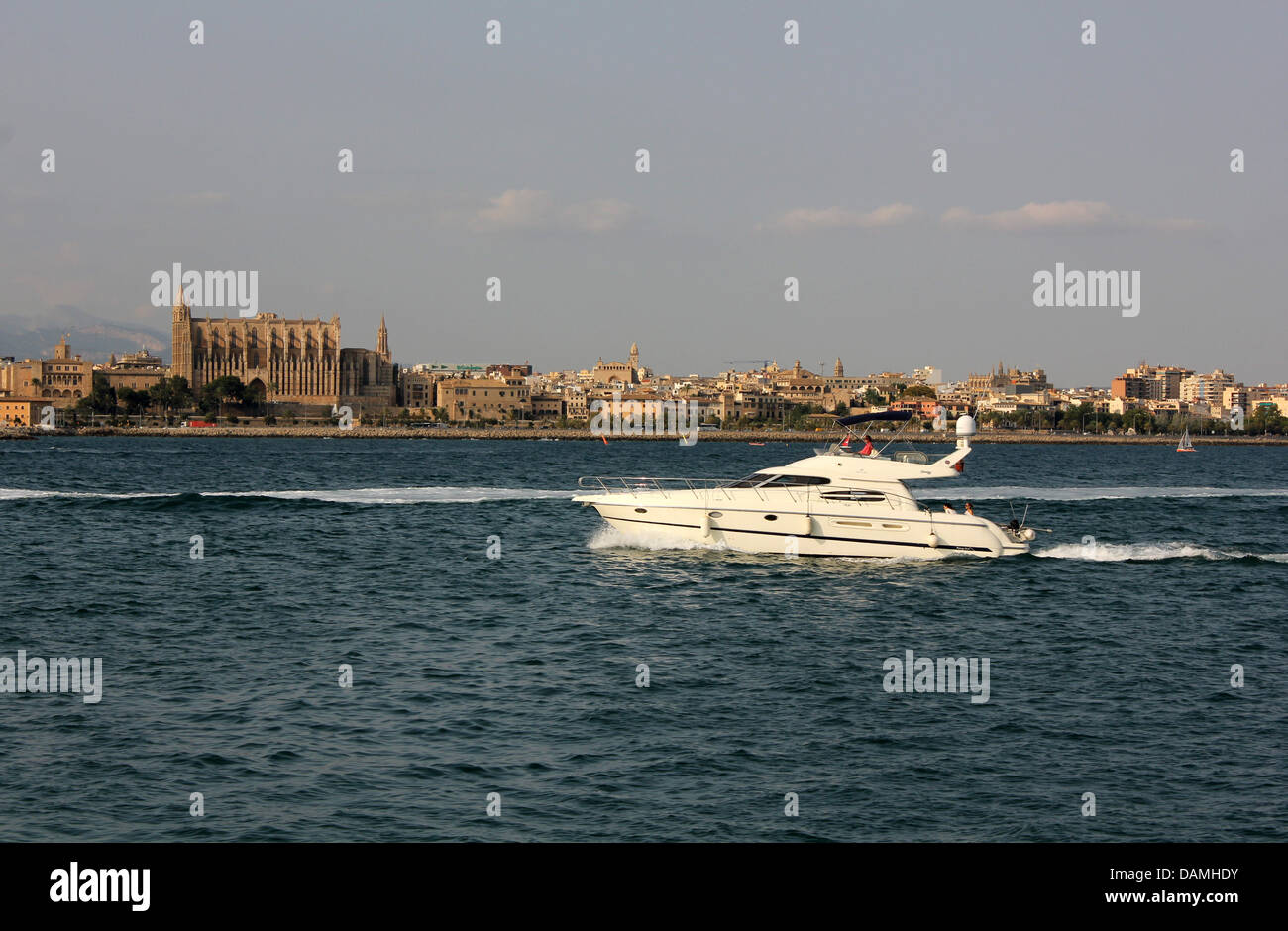 Motor yacht returning to port / marina at late afternoon past historic ...