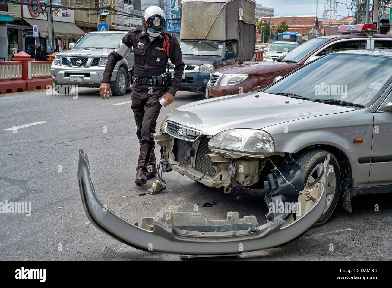 Detail of vehicle frontal damage of a car accident with policeman using ...