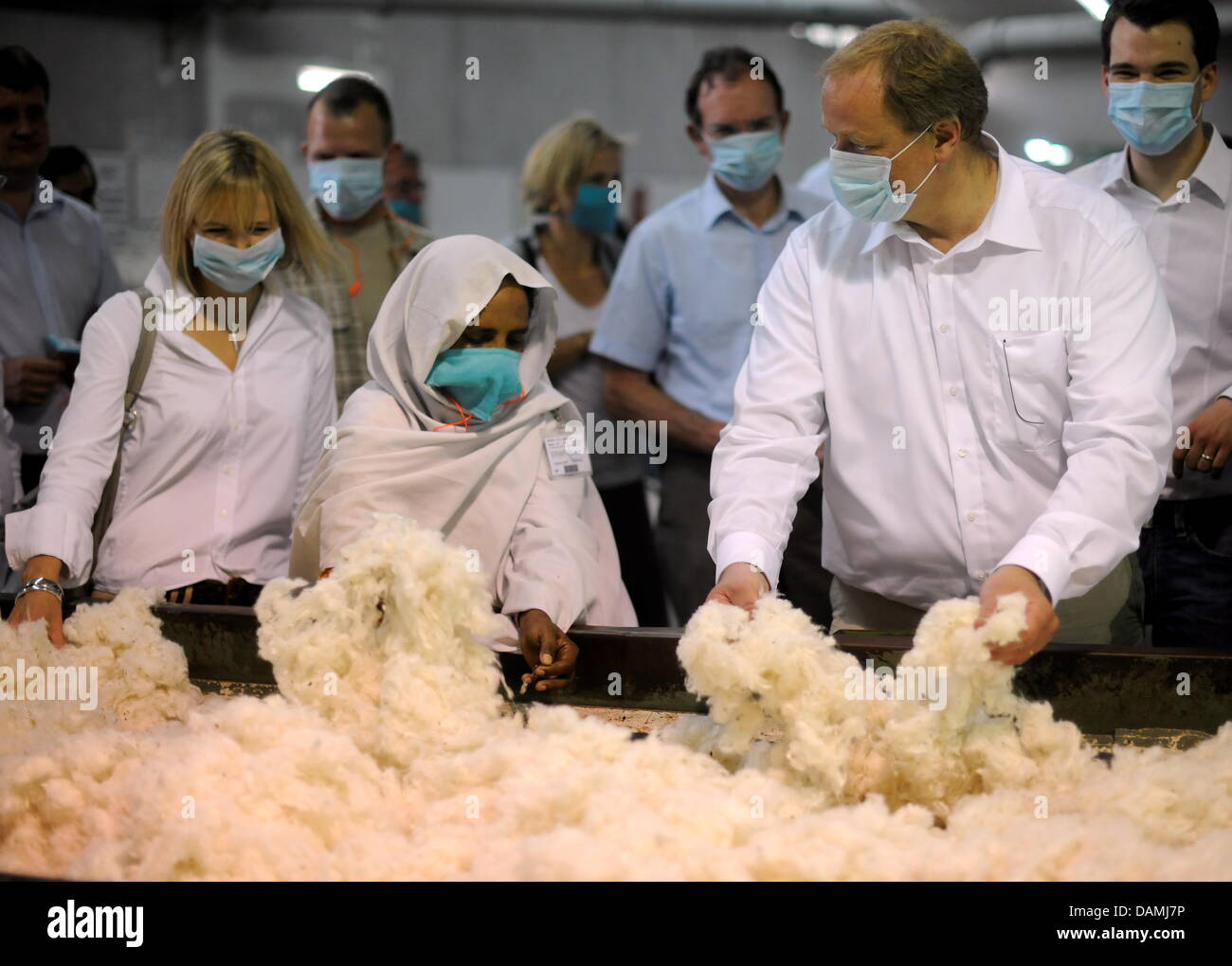 Development aid minister Dirk Niebel (R) visits the textile factory ...