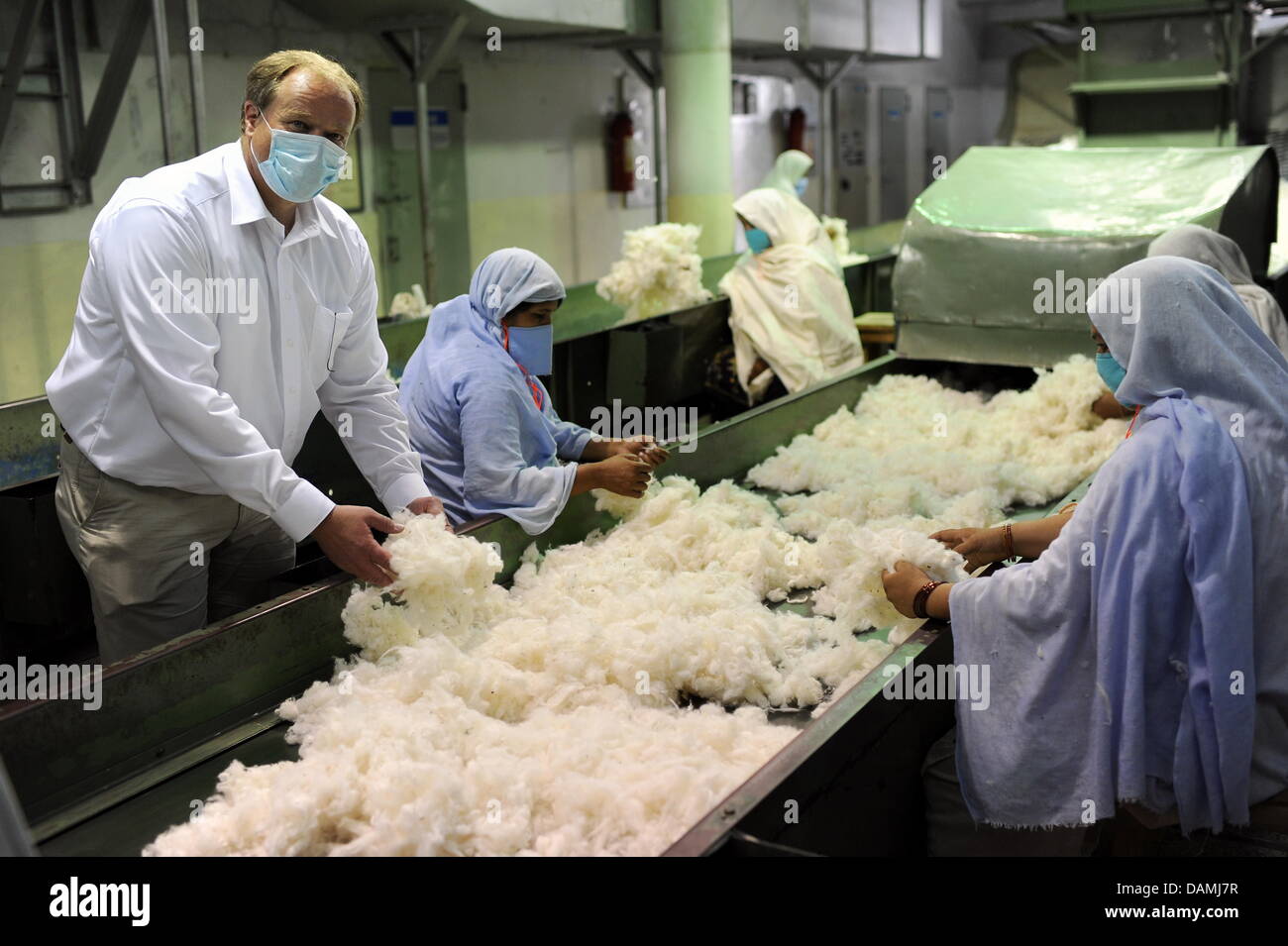 Development aid minister Dirk Niebel (L) visits the textile factory ...