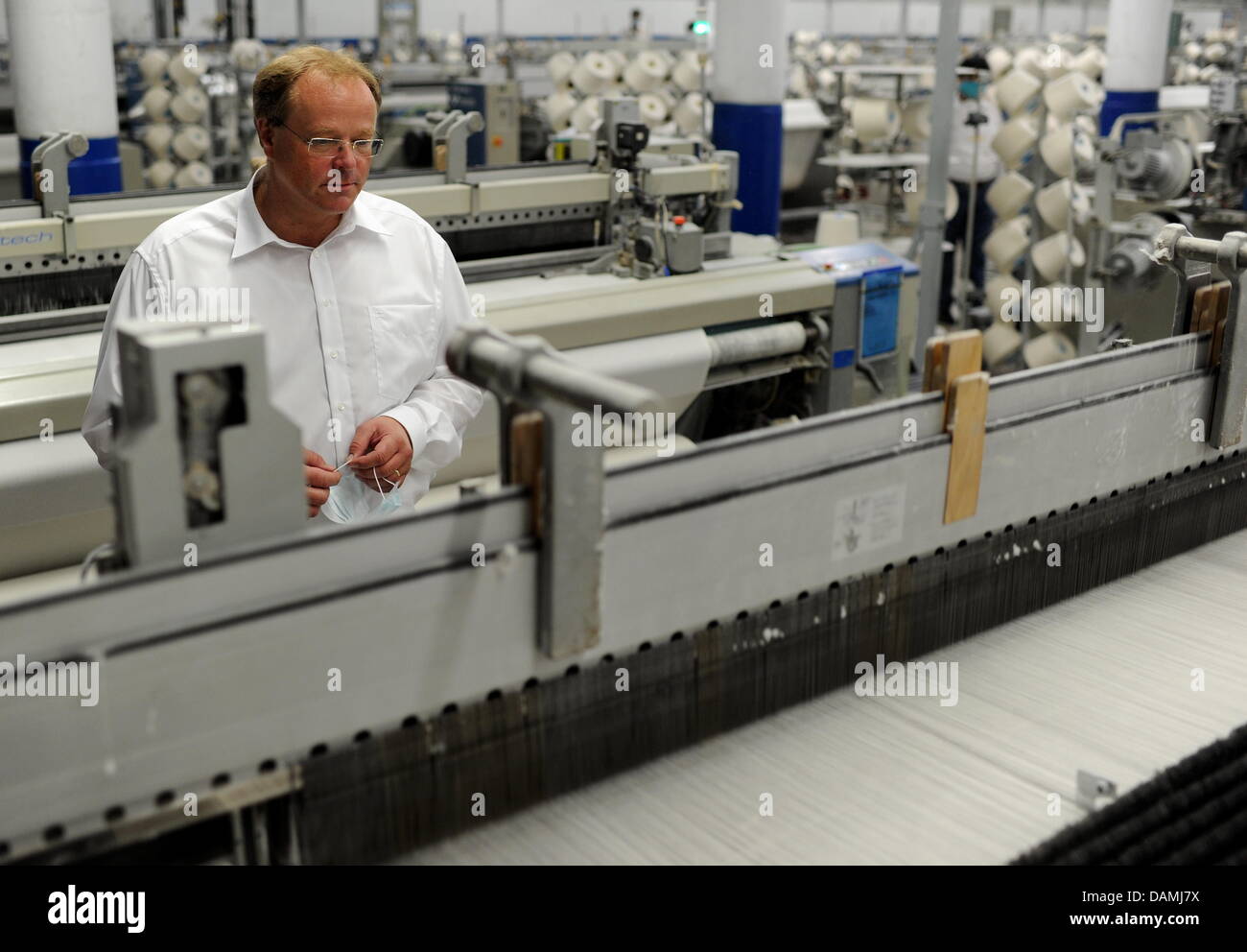 Development aid minister Dirk Niebel (FRONT) visits the textile factory ...
