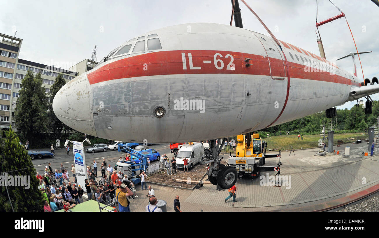 An old IL-62 of the GDR airline Interflug is lifted onto three steel ...