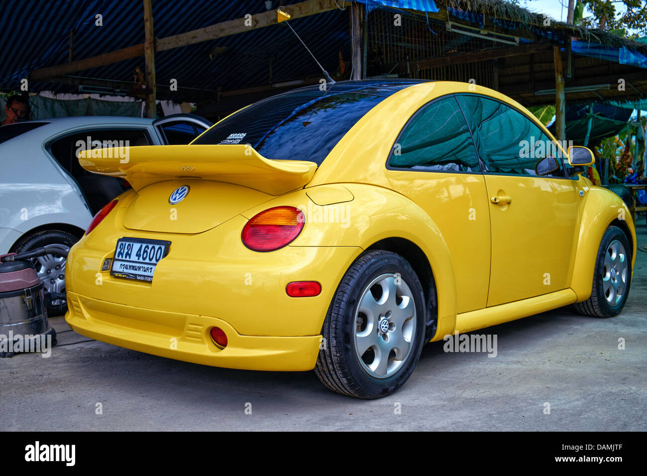 Volkswagen Beetle vivid yellow modern VW motorcar. Thailand S. E. Asia ...