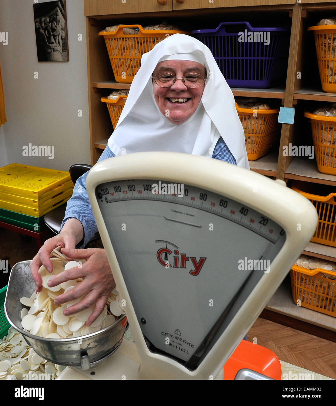 Sister Theresia weighs sacramental bread at the Benedictine abbey St ...
