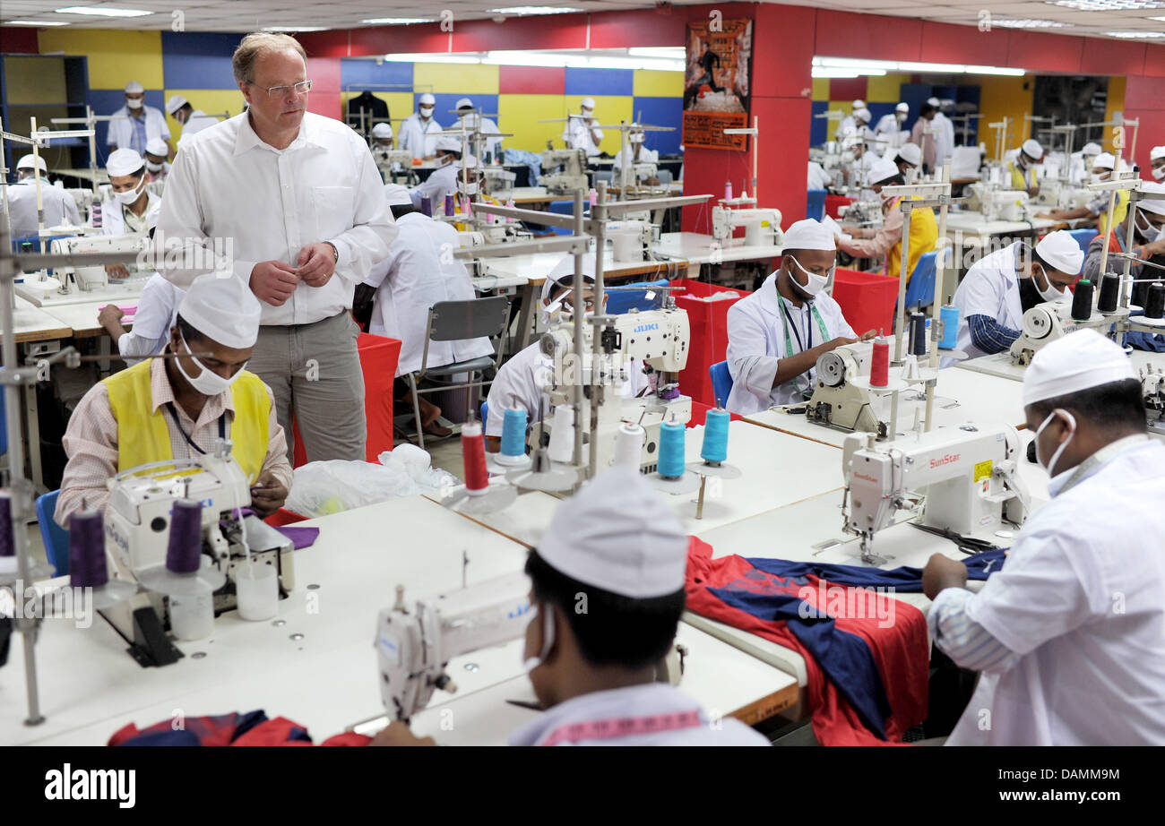 German Development Minister Dirk Niebel visits a textile factory in ...