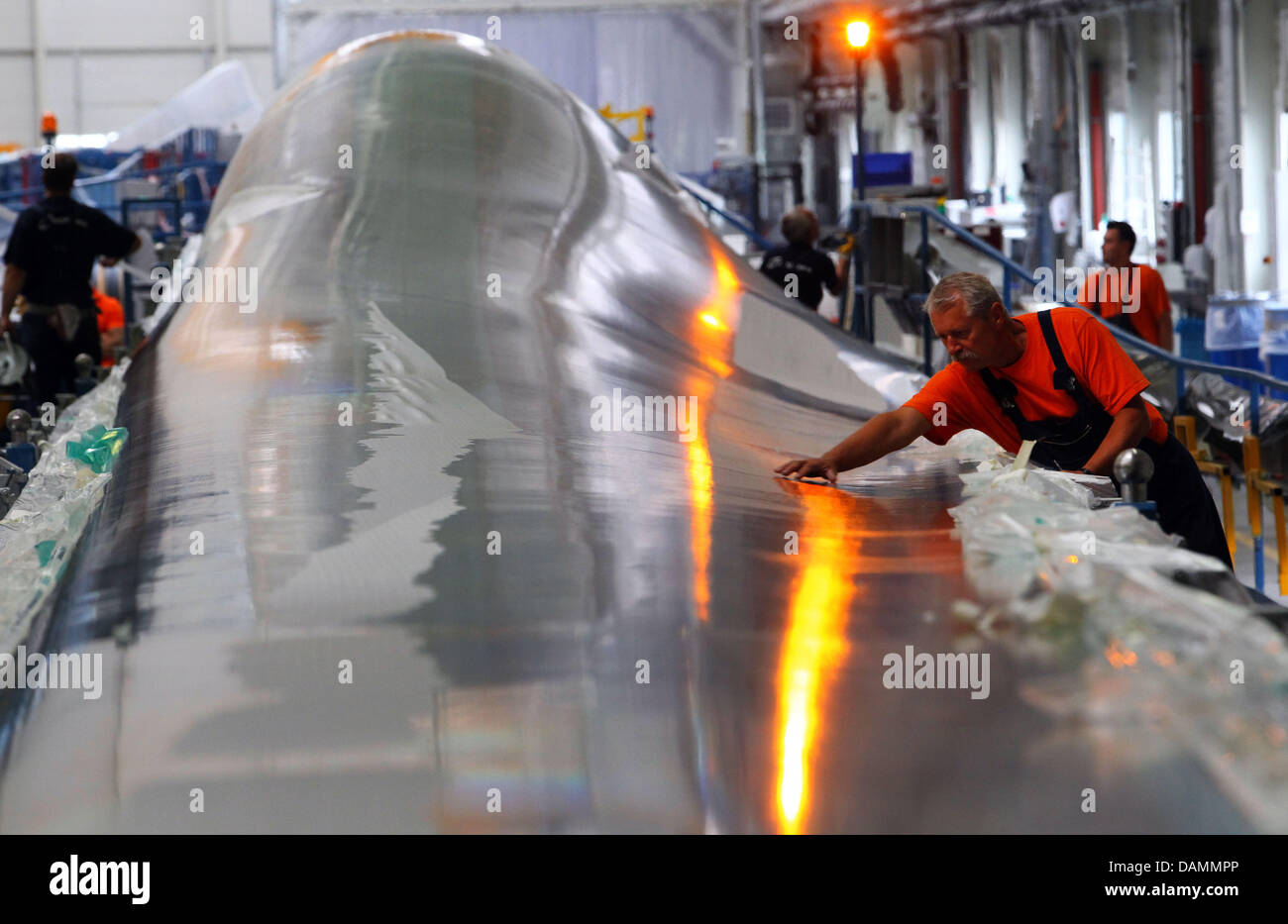 A Nordex employee checks wind turbine rotor blades in Rostock, Germany ...