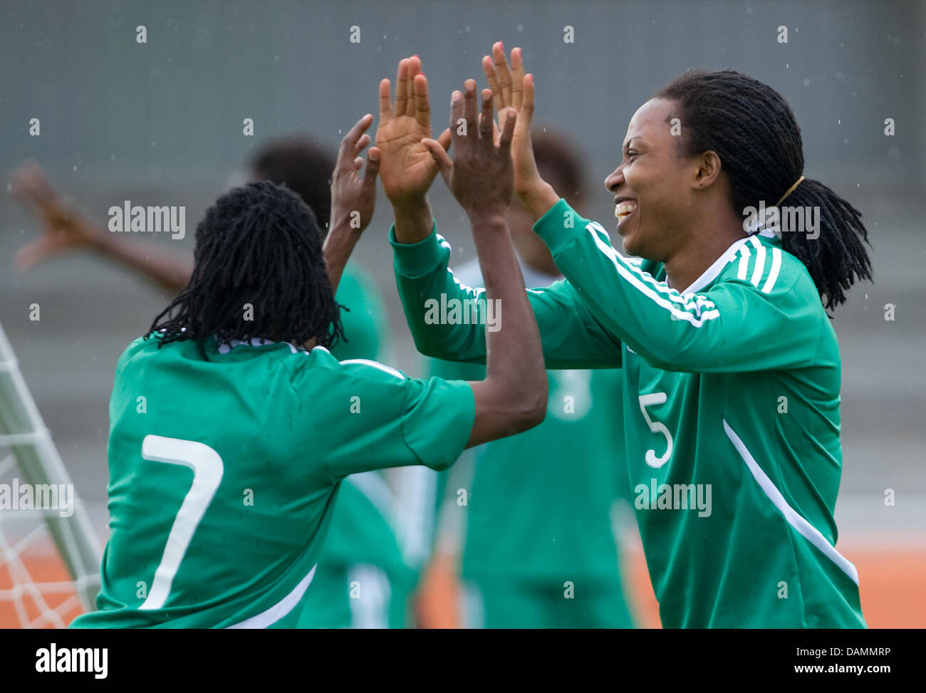 Nigerian national soccer players Onome Ebi (R) and Stella Mbachu shake ...