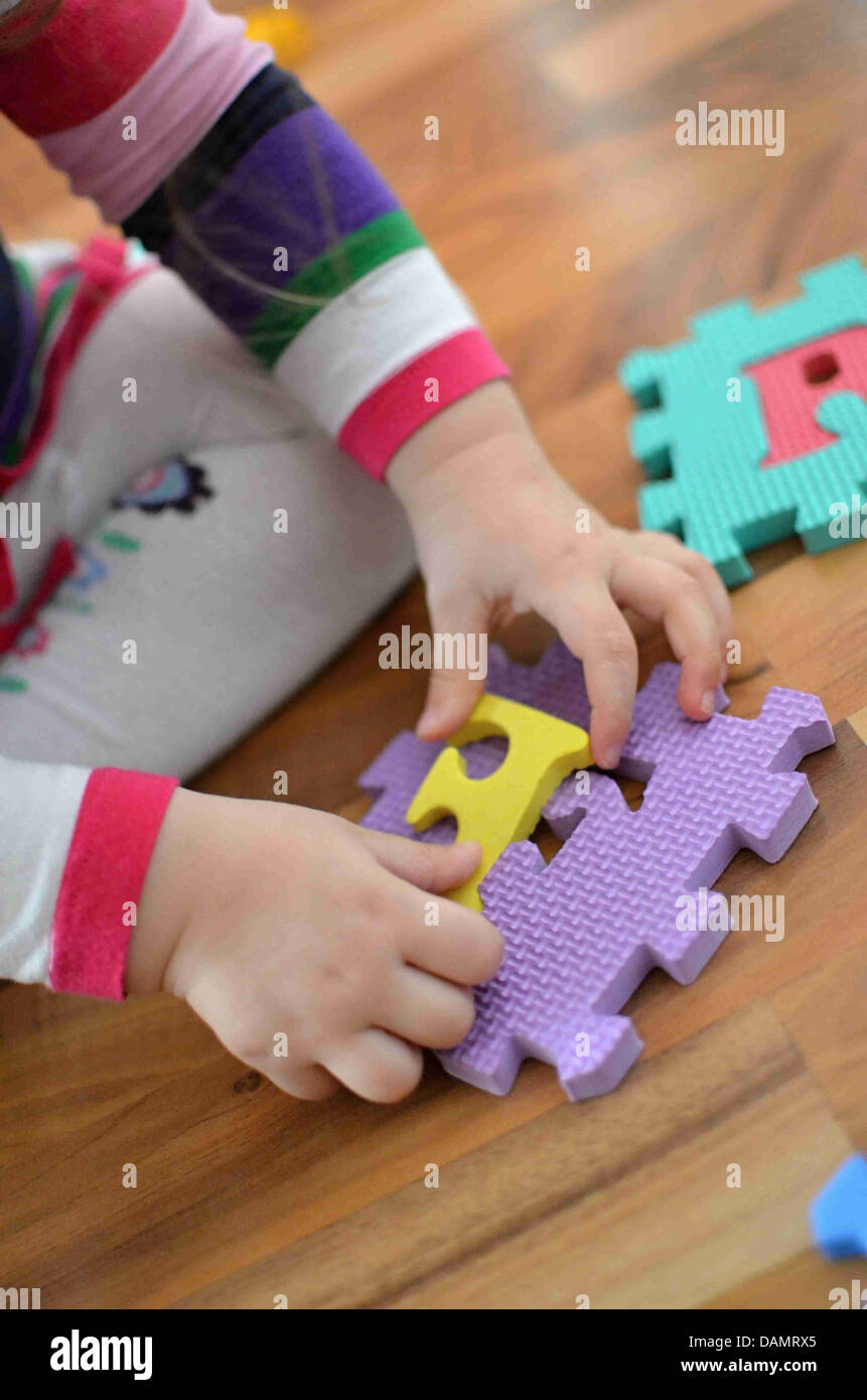 Puzzle in children hands Stock Photo - Alamy