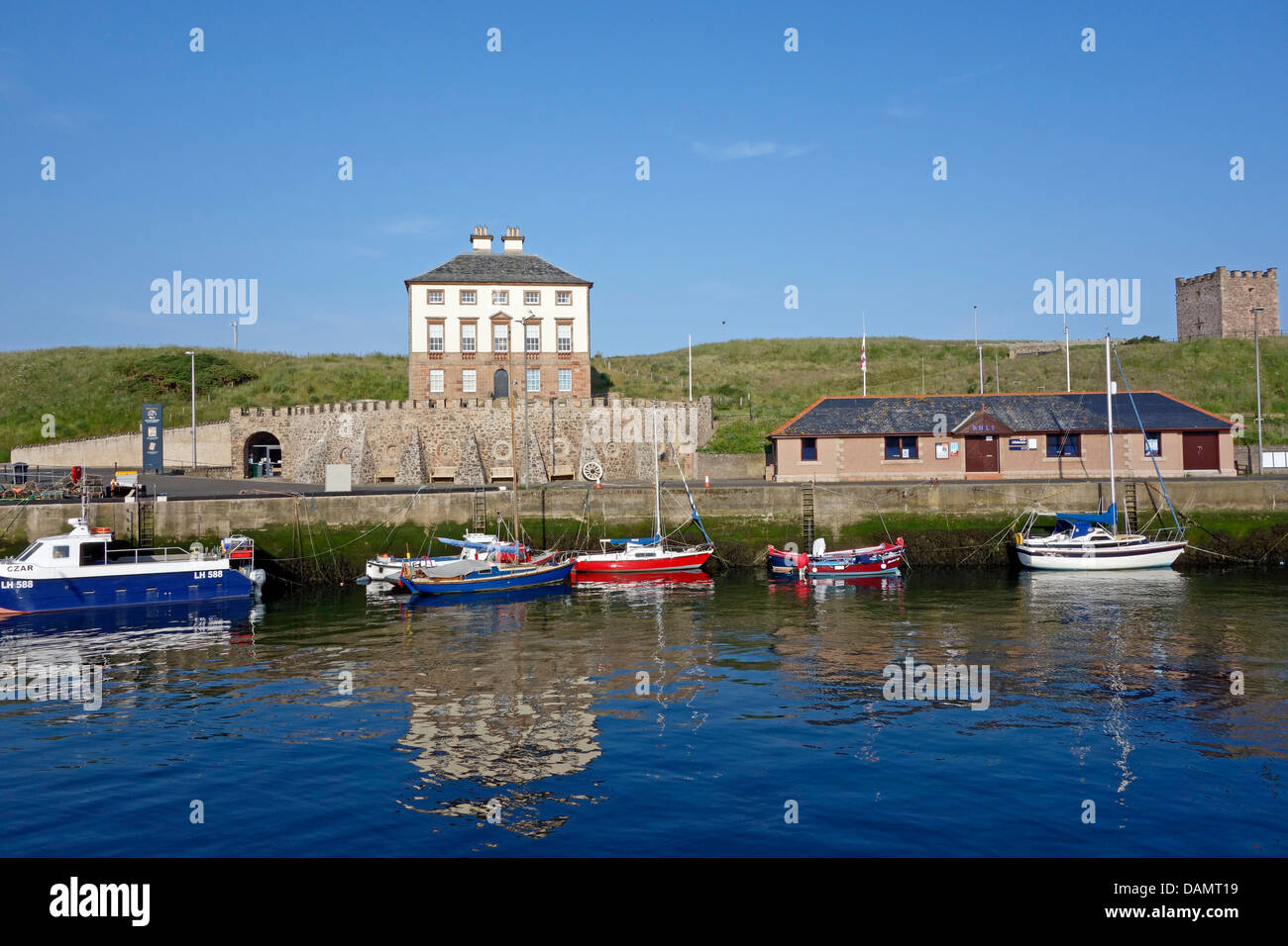 Eyemouth harbour in East Lothian Scotland with Gunsgreen House and ...