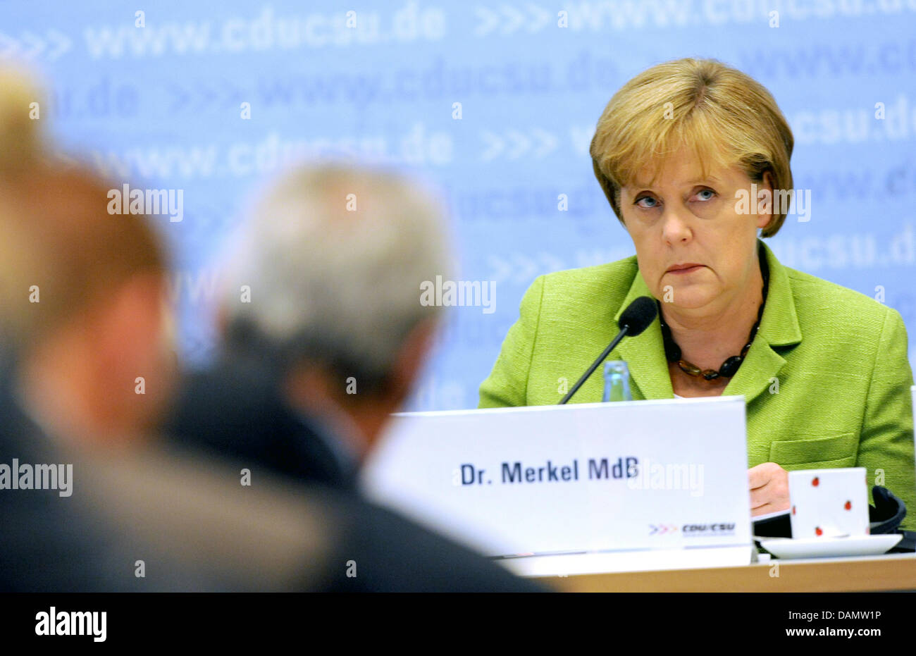 German Chancellor Angela Merkel (CDU) sits on the podium as she speaks ...