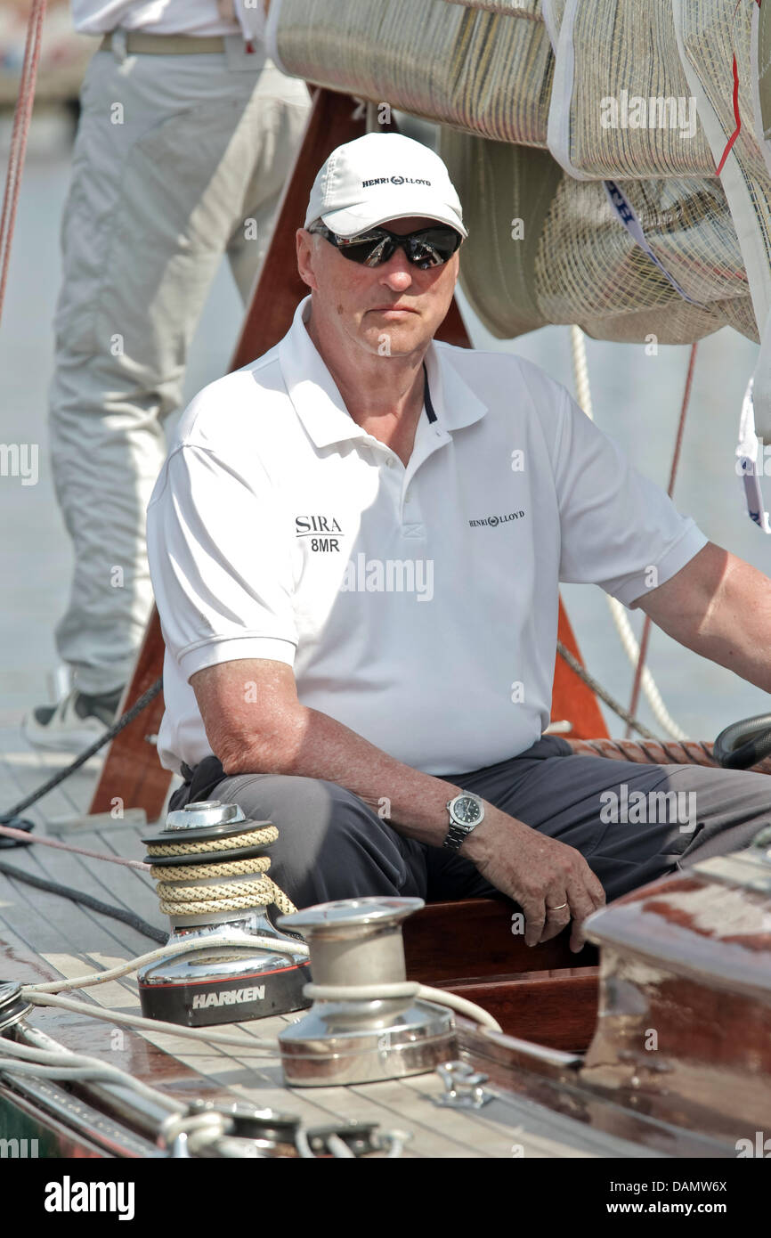 King Harald V of Norway sits at the helm of his boat Sira at the ...