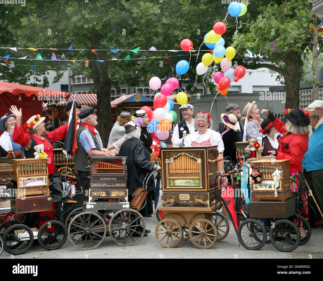 Barrel organ players stand behind their organs during the 12th ...