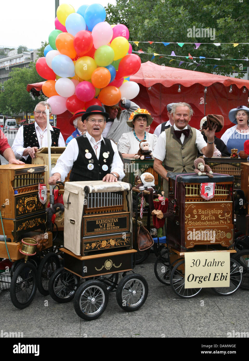Barrel organ players stand behind their organs during the 12th ...