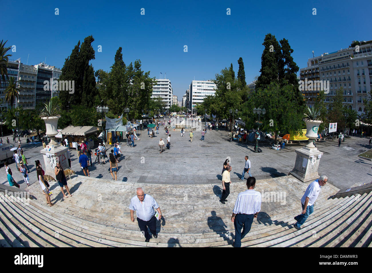 Passers-by walk across the square which was the site of yesterday's ...