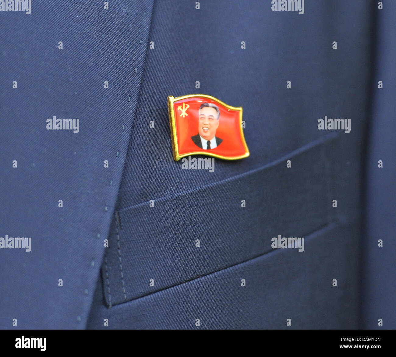 Head coach Kim Kwang Min of North Korea wear a pin with the portrait of ...