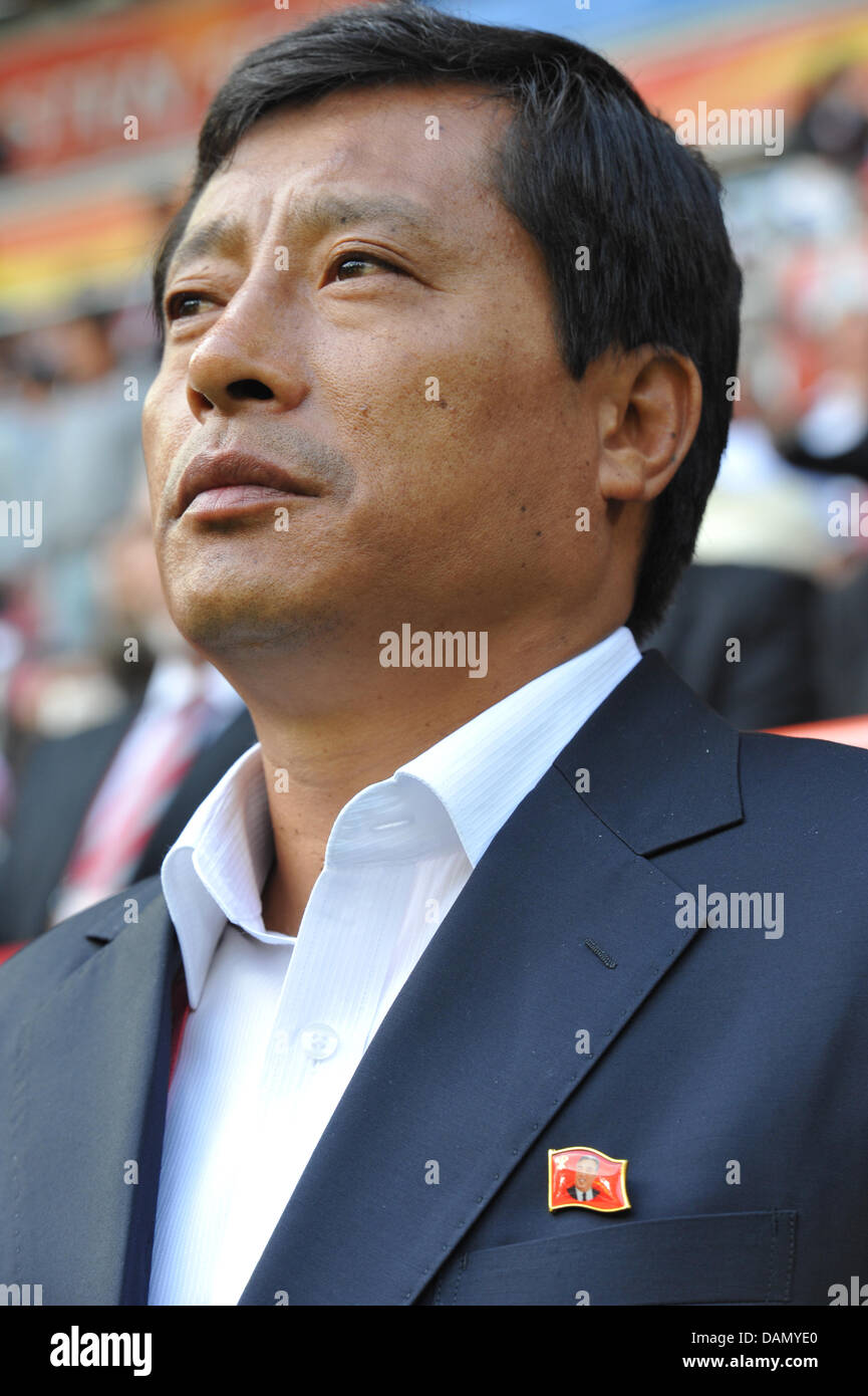 Head coach Kim Kwang Min of North Korea wears a pin with the portrait ...
