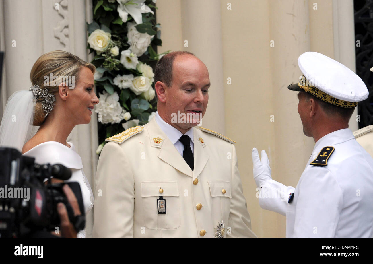 Prince Albert II (C) and Princess Charlene of Monaco leave the Saint ...
