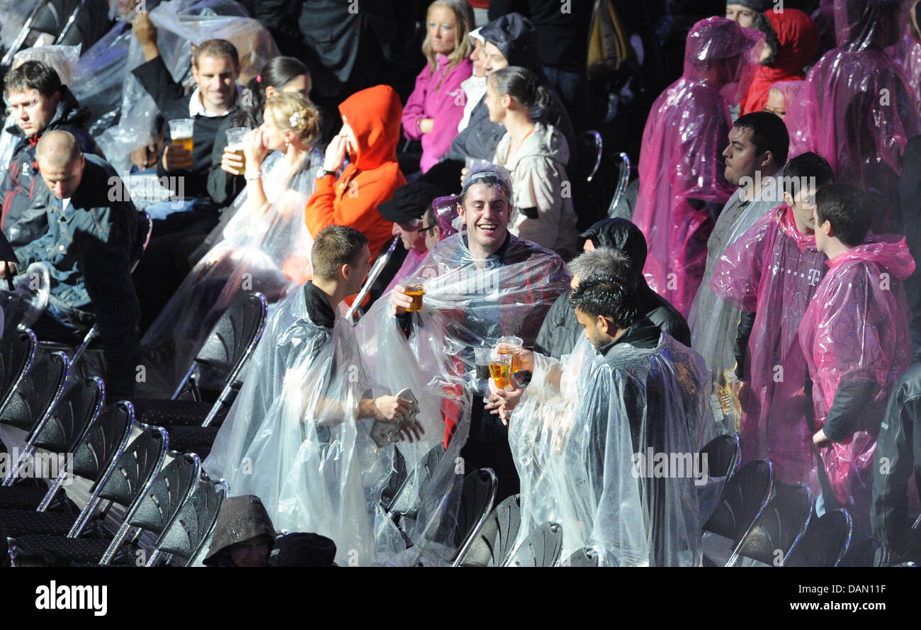 People in the audience wear rain capes during the world championships ...