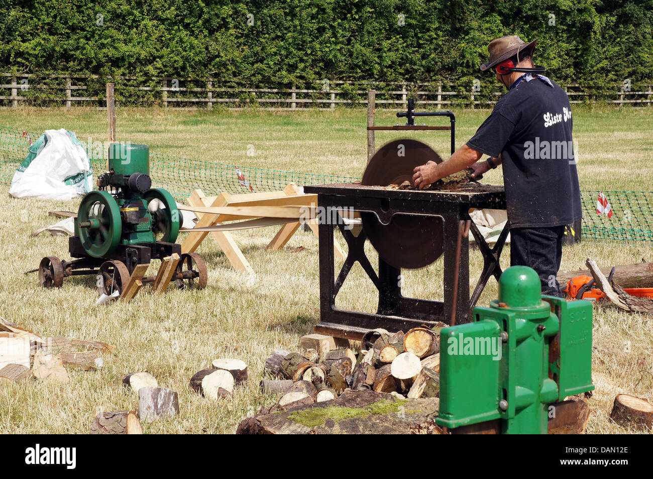 Male cutting wood on a steam-powered saw Stock Photo - Alamy
