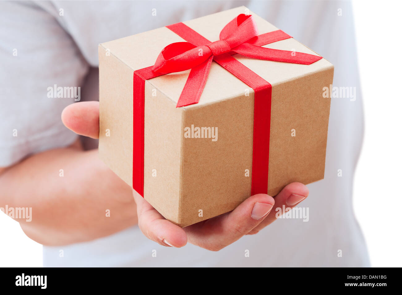 Male hand holding gift box with red ribbon Stock Photo - Alamy