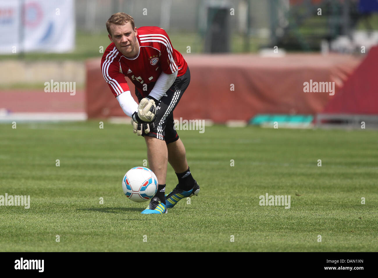 FC Bayern Munich's goalkeeper Manuel Neuer rolls the ball to a teammate ...