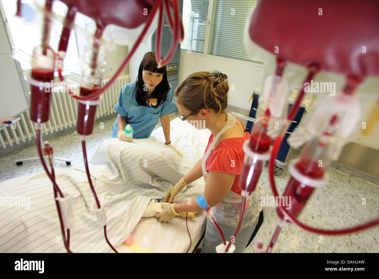 Medical student Lisette (R) receives supervision from her tutor Kristin ...