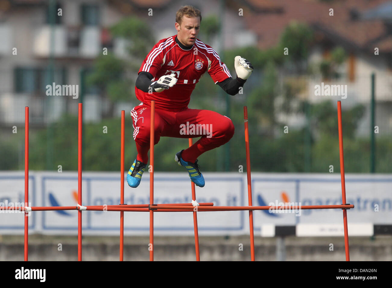 The keeper of FC Bayern Munich, Manuel Neuer, jumps over a hurdle ...