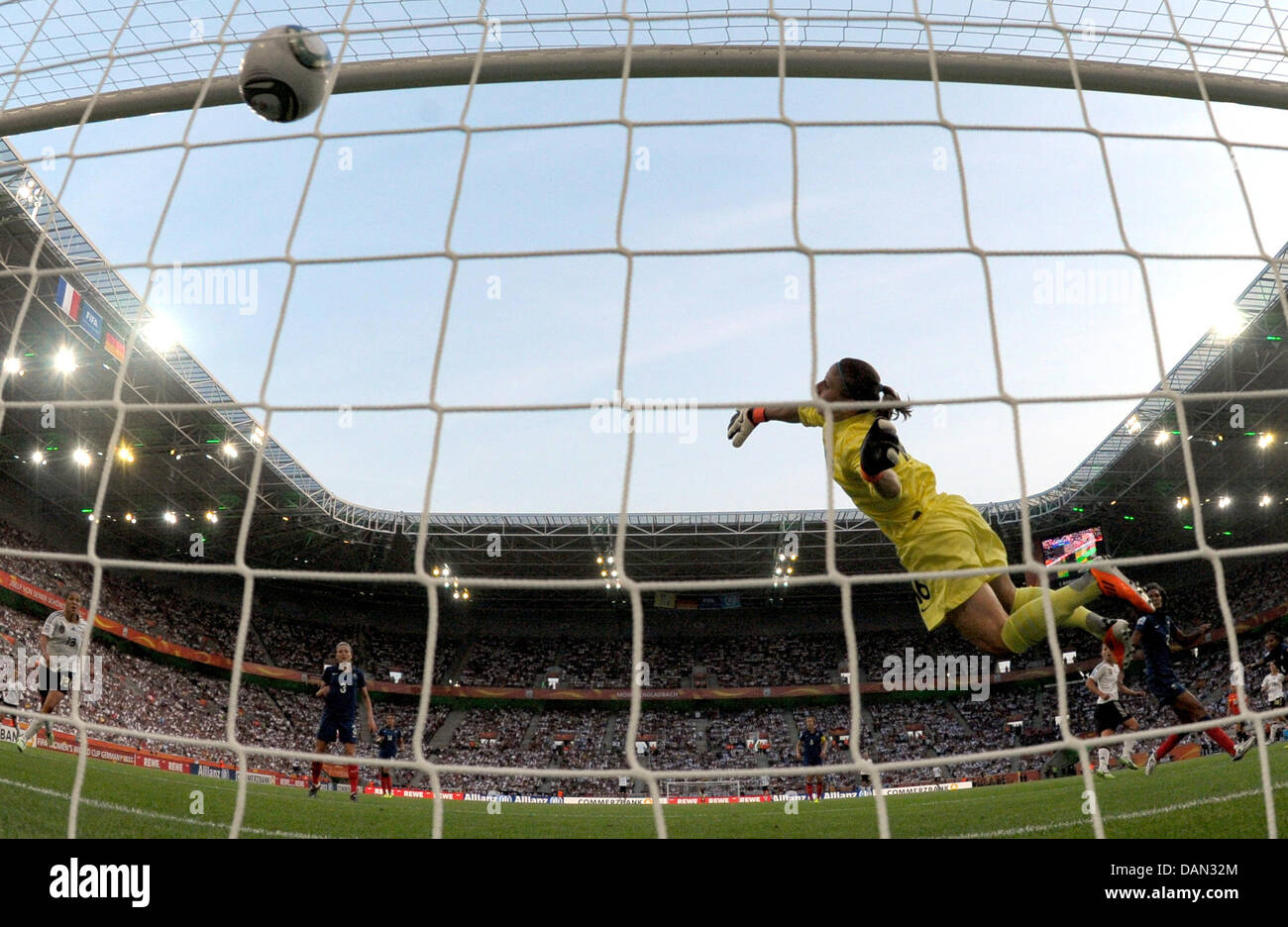 Germany's Inka Grings (unseen) scores the 2-0 against Berangere ...