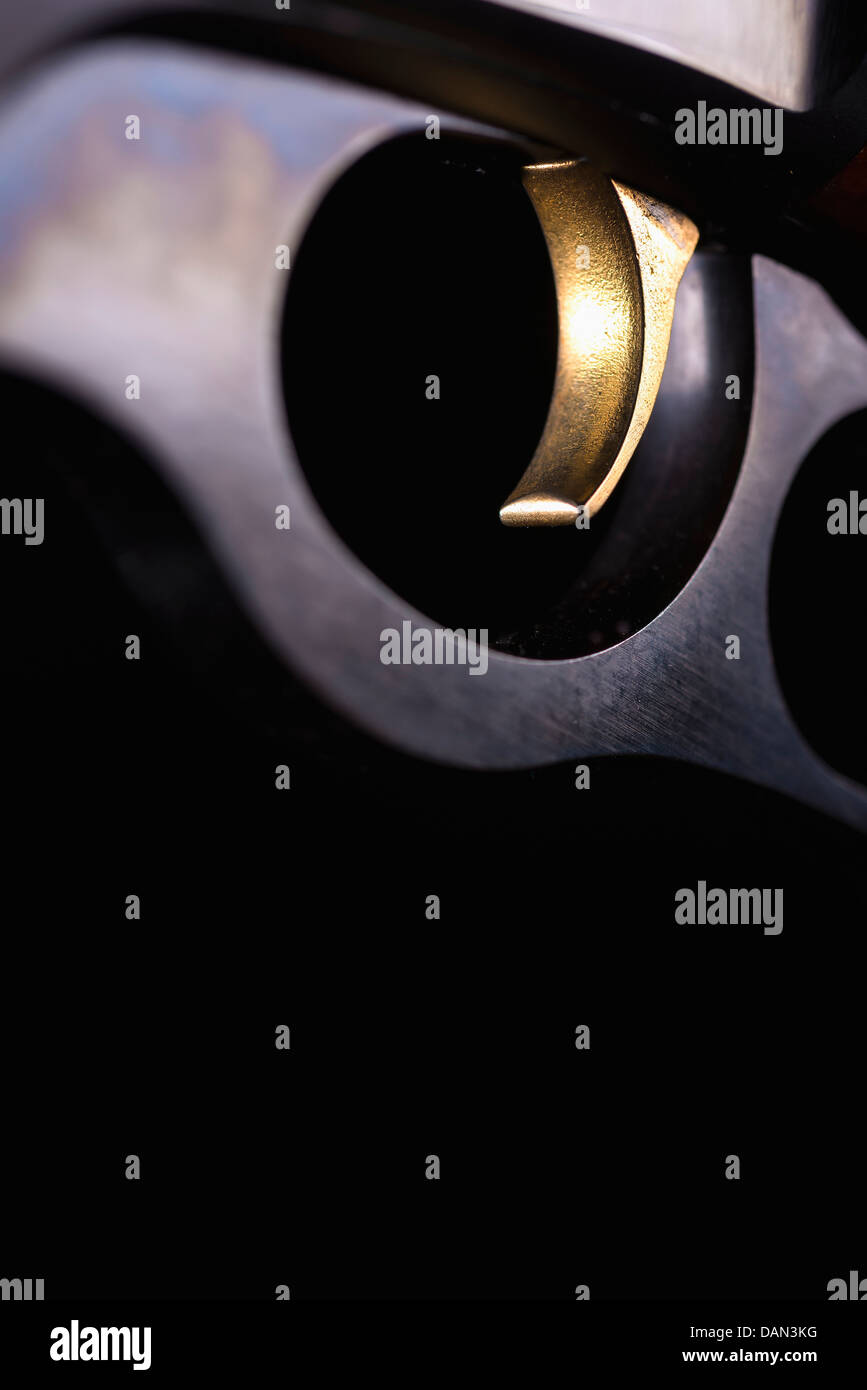 Trigger of gun against black background, close up Stock Photo - Alamy