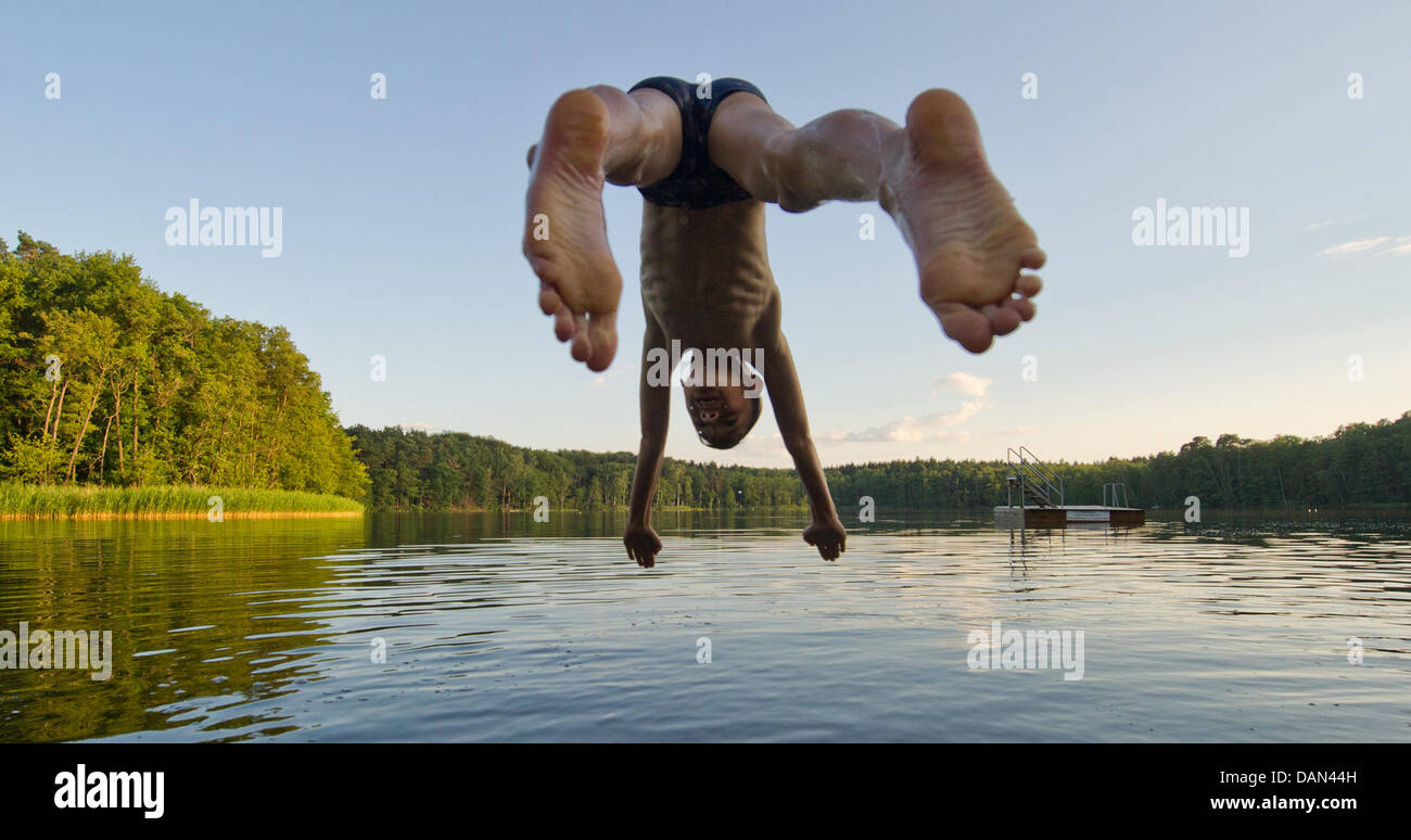 A boy jumps into the water of the Treplin Lake in Treplin, Germany, 05 ...