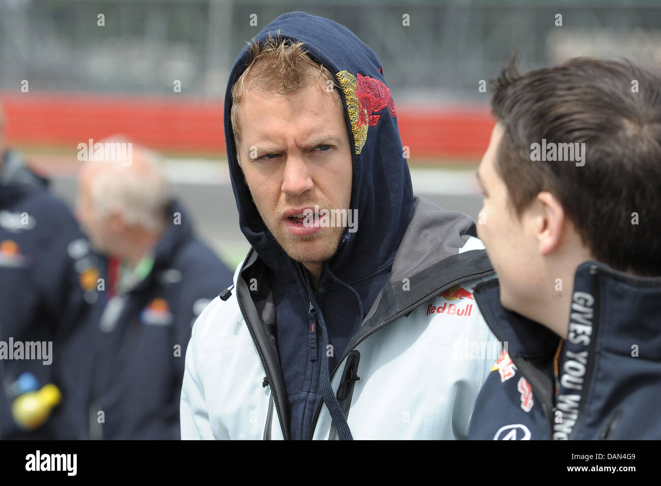 German Formula One driver Sebastian Vettel (L) of Red Bull walks with ...