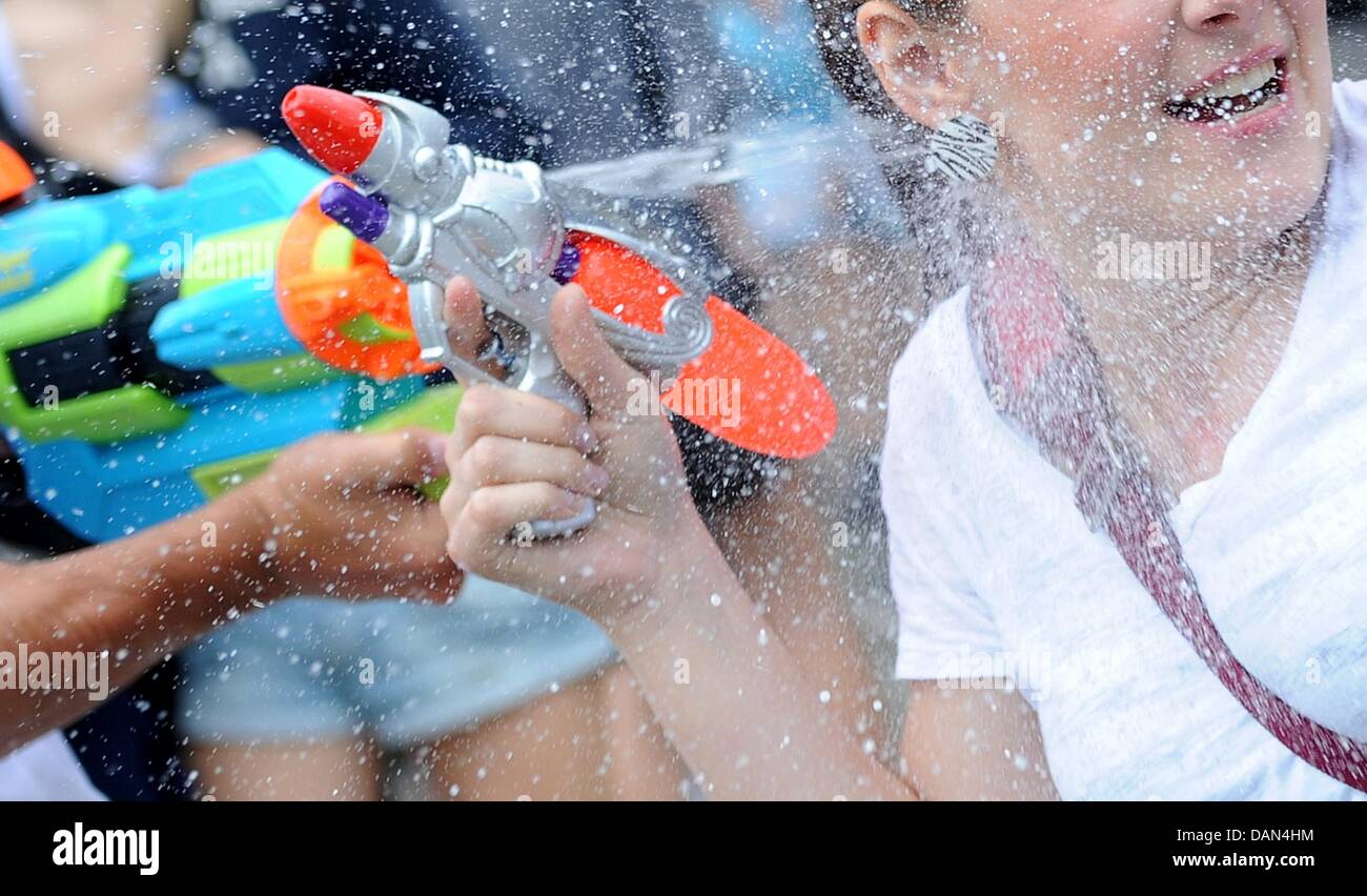 Young people participate in a water fight in front of central station ...
