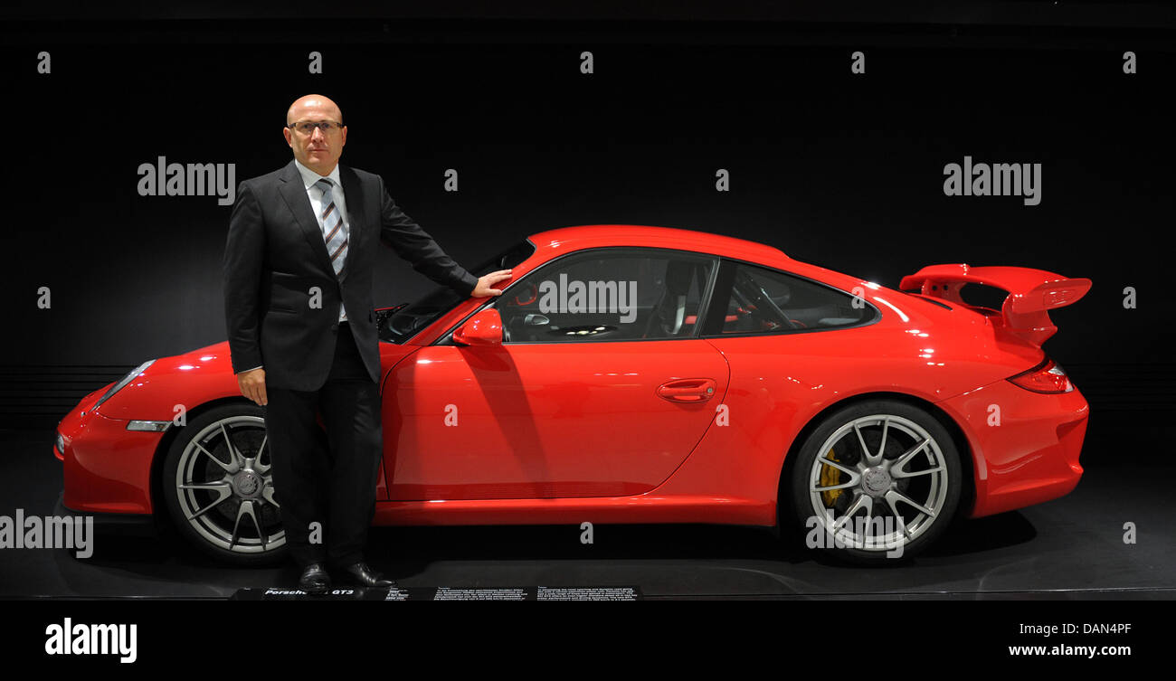 Porsche Sales and Marketing CEO Bernhard Maier stands next to a Porsche ...