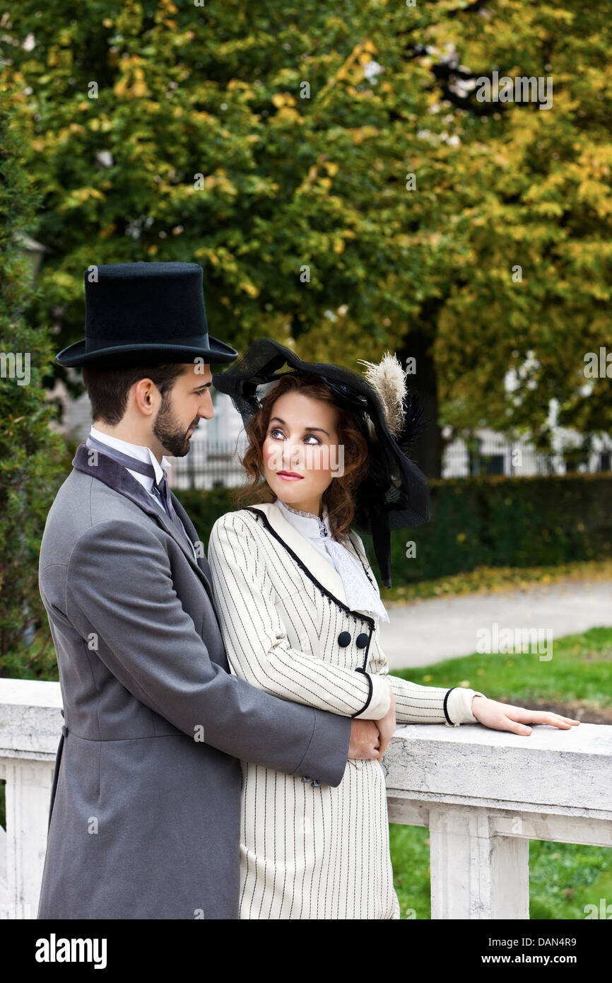 A loving couple, dressed in the style in the end of the 19th century ...